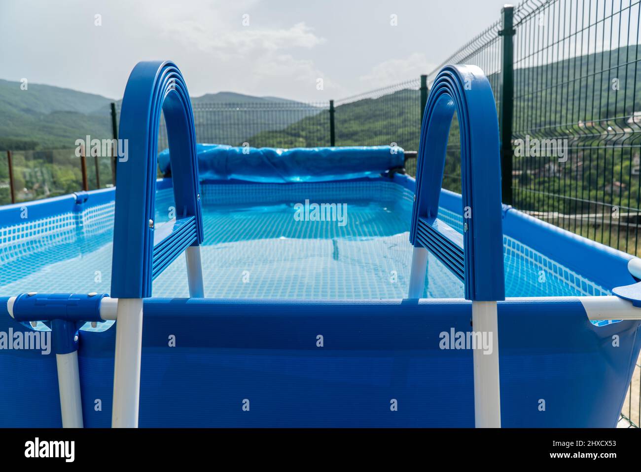 Outdoor portable pool with amazing view to the mountains. First person ...