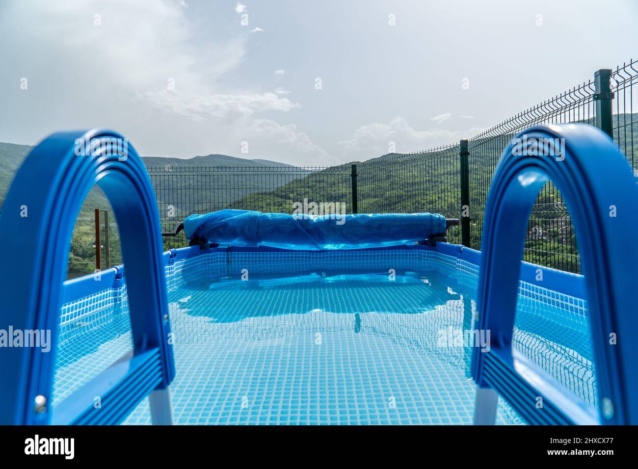 Outdoor portable pool with amazing view to the mountains. First person ...