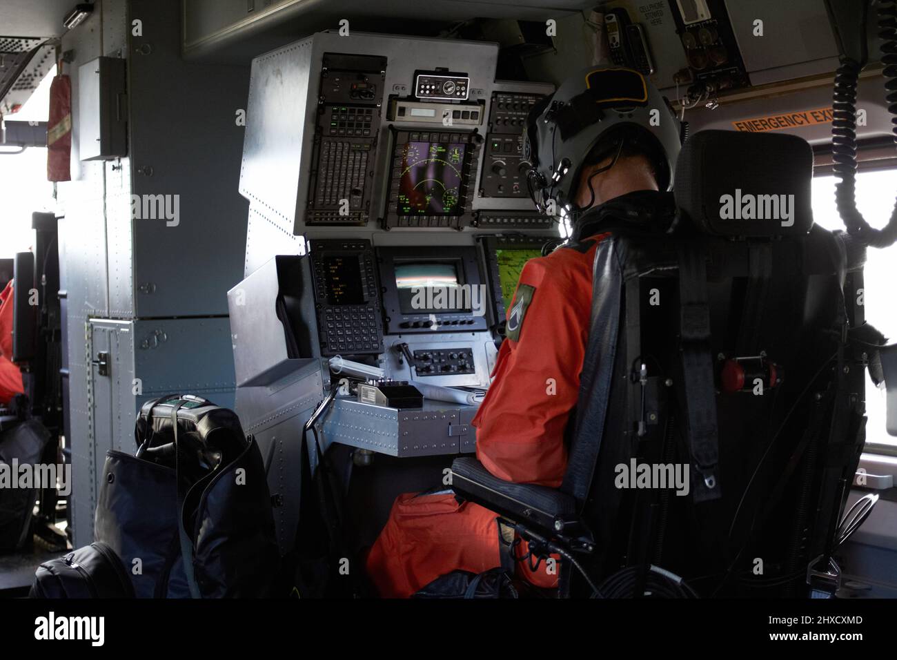 Hell fly you to safety. Young male pilot concentrating in his cockpit ...