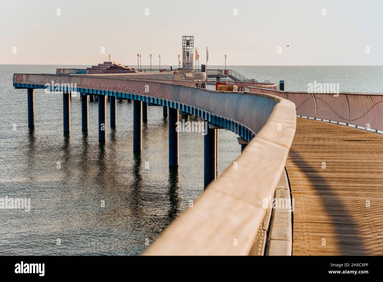 The new curved pier in Koserow to the sunrise-people empty Stock Photo ...