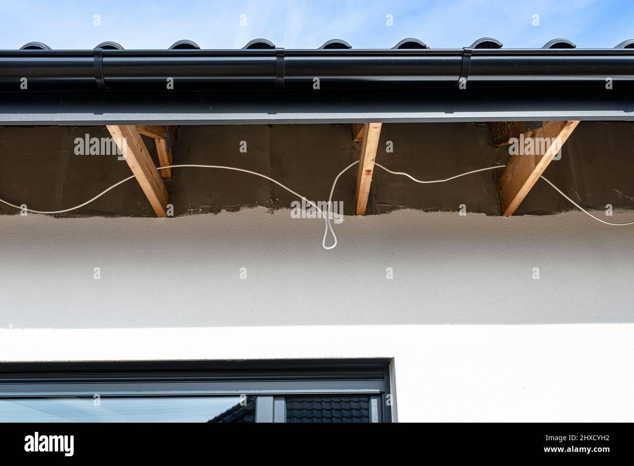 Roof trusses through which the electric cable passes to connect the ...