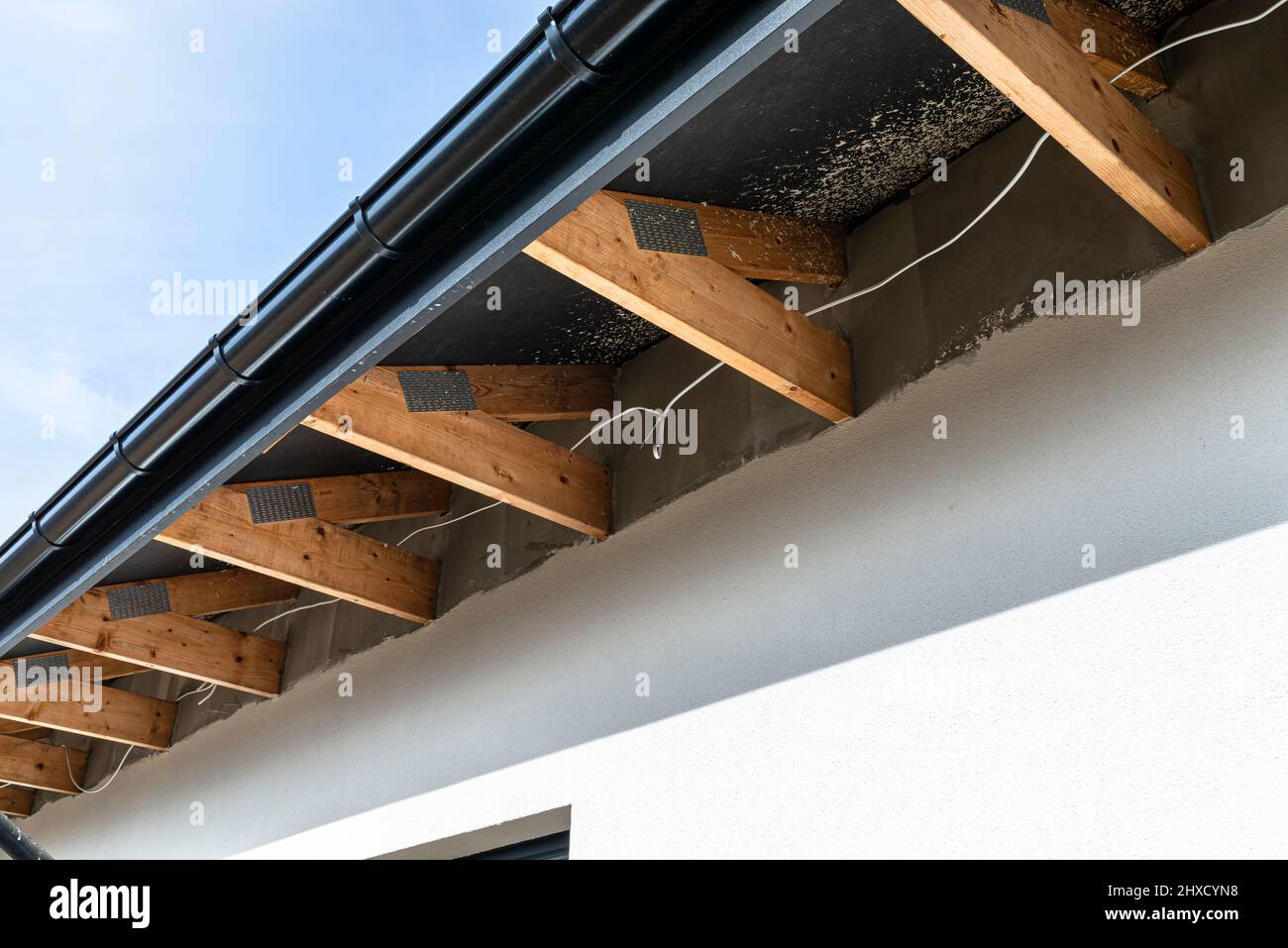 Roof trusses through which the electric cable passes to connect the ...