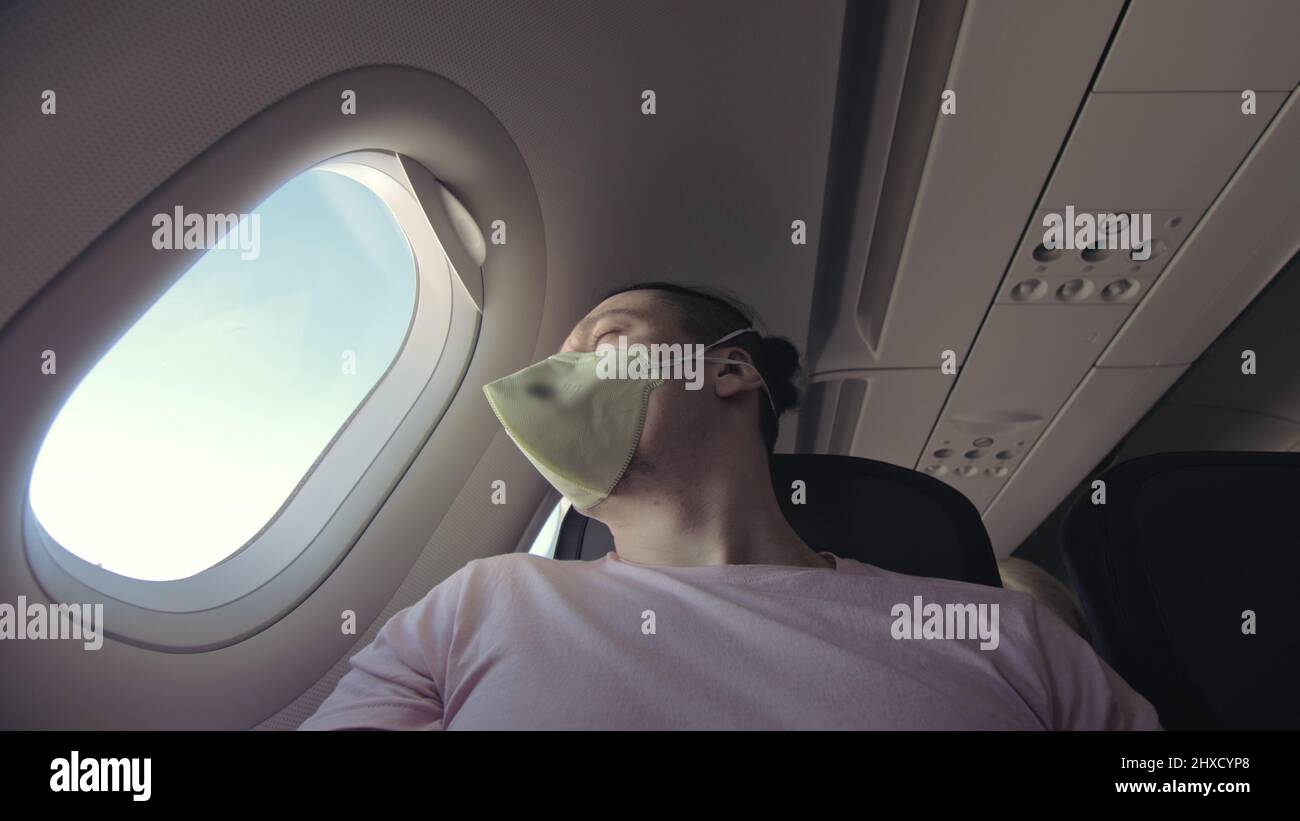 Man travel caucasian at plane with wearing protective medical mask ...
