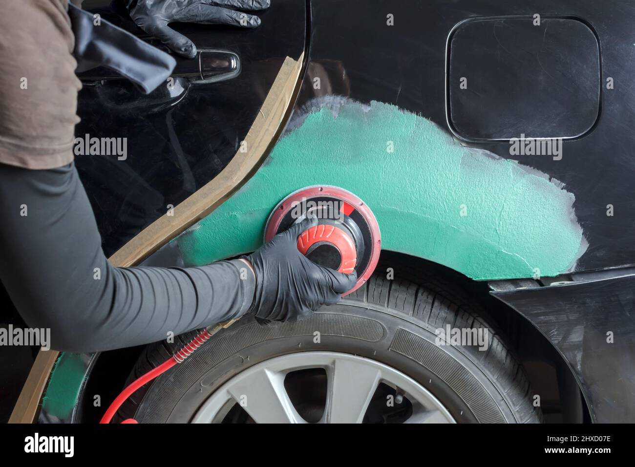 Grinding body parts with a pneumatic grinder before painting Stock ...