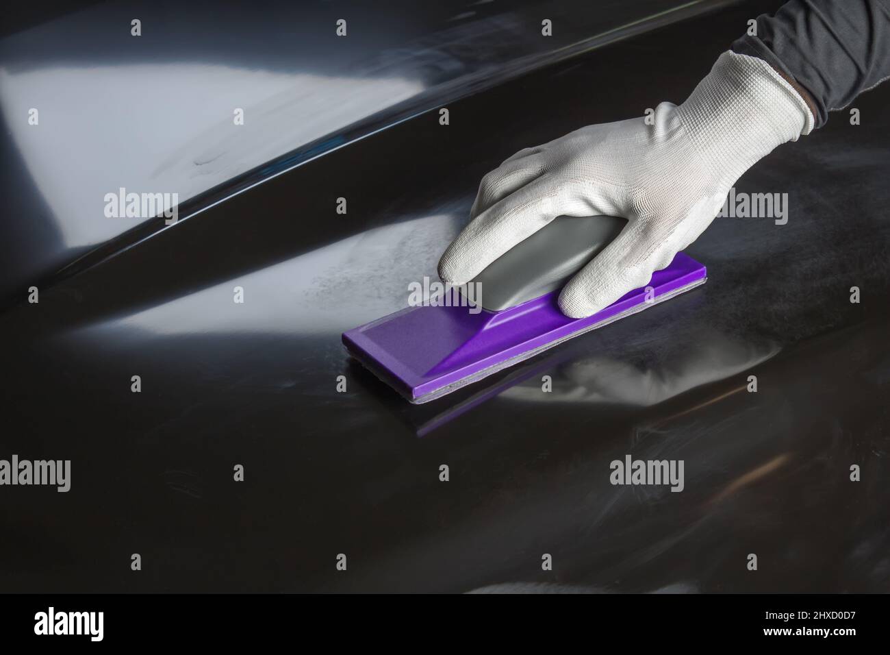 Grinding car body parts with a manual sanding planer before painting ...