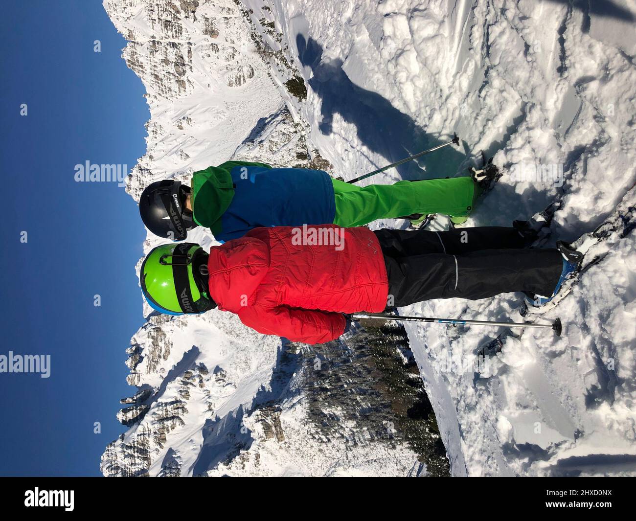 Two small skiers look at the Schlicker peaks in the ski resort Schlick ...