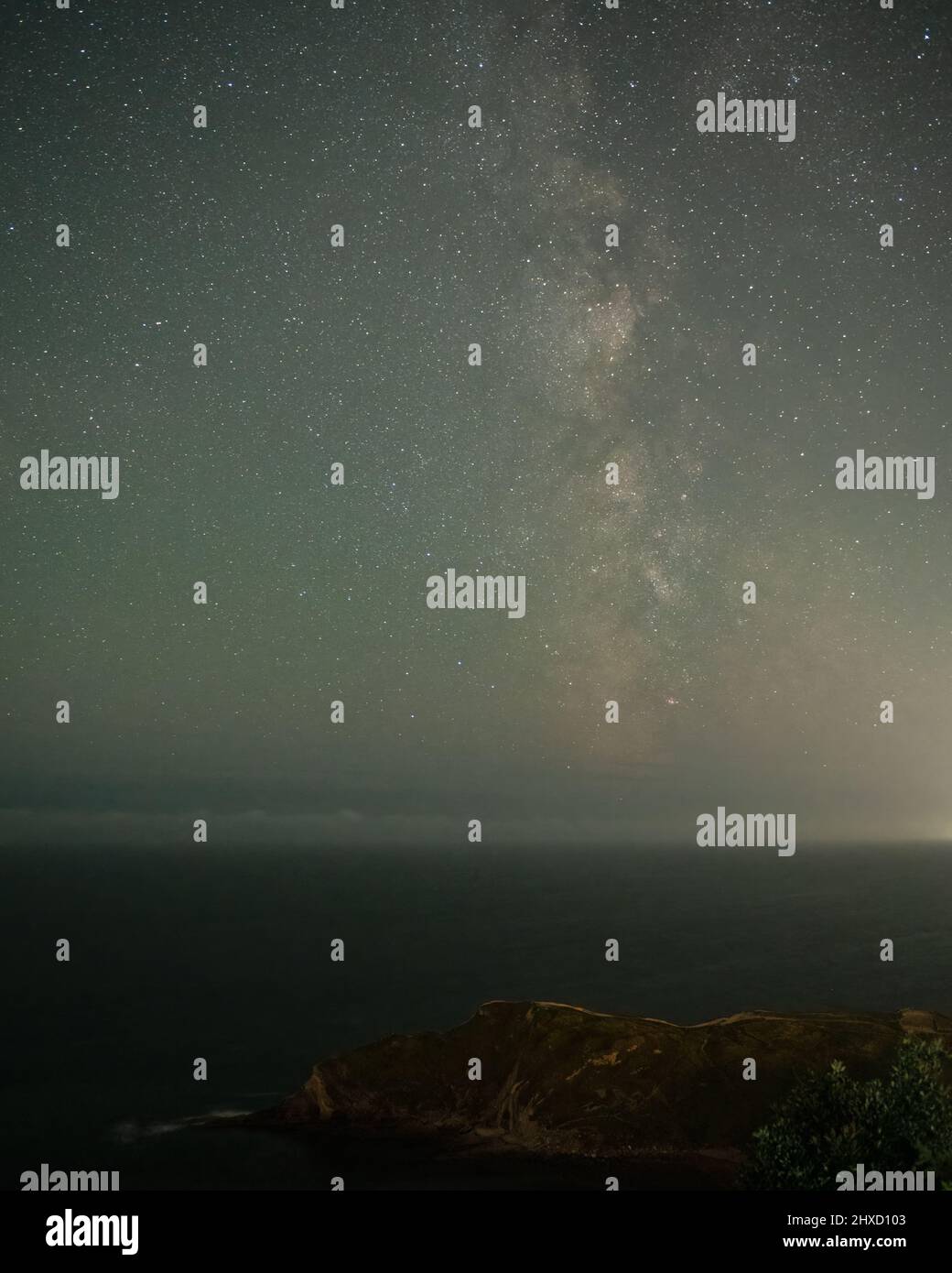 the Milky Way rising above the entrance to Lulworth Cove, Dorset ...