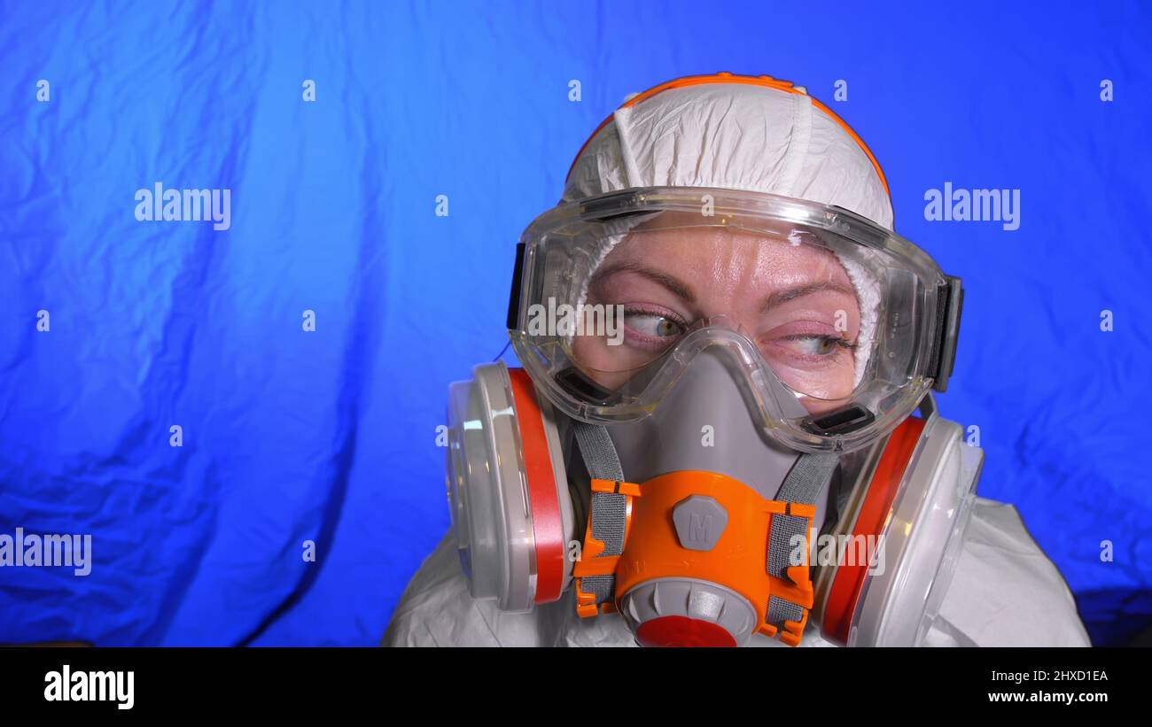 Scientist virologist in respirator. Slow motion. Woman close up look ...