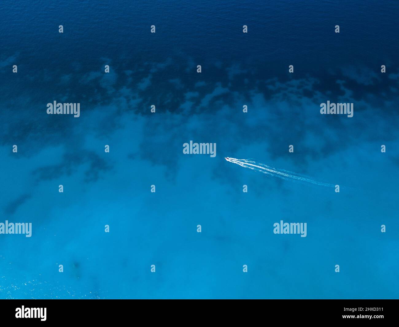 aerial view of speed boat making waves in blue sea water Stock Photo ...