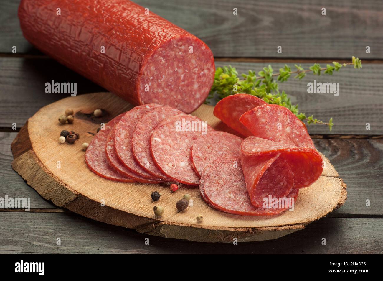 italian type pork salami on a dark set(whole and slices Stock Photo - Alamy