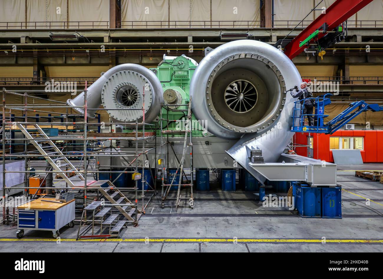 Industrial mechanic working on a gear compressor, MAN Energy Solutions ...