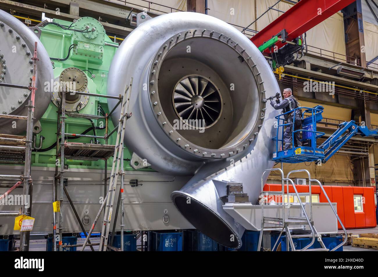 Industrial mechanic working on a gear compressor, MAN Energy Solutions ...