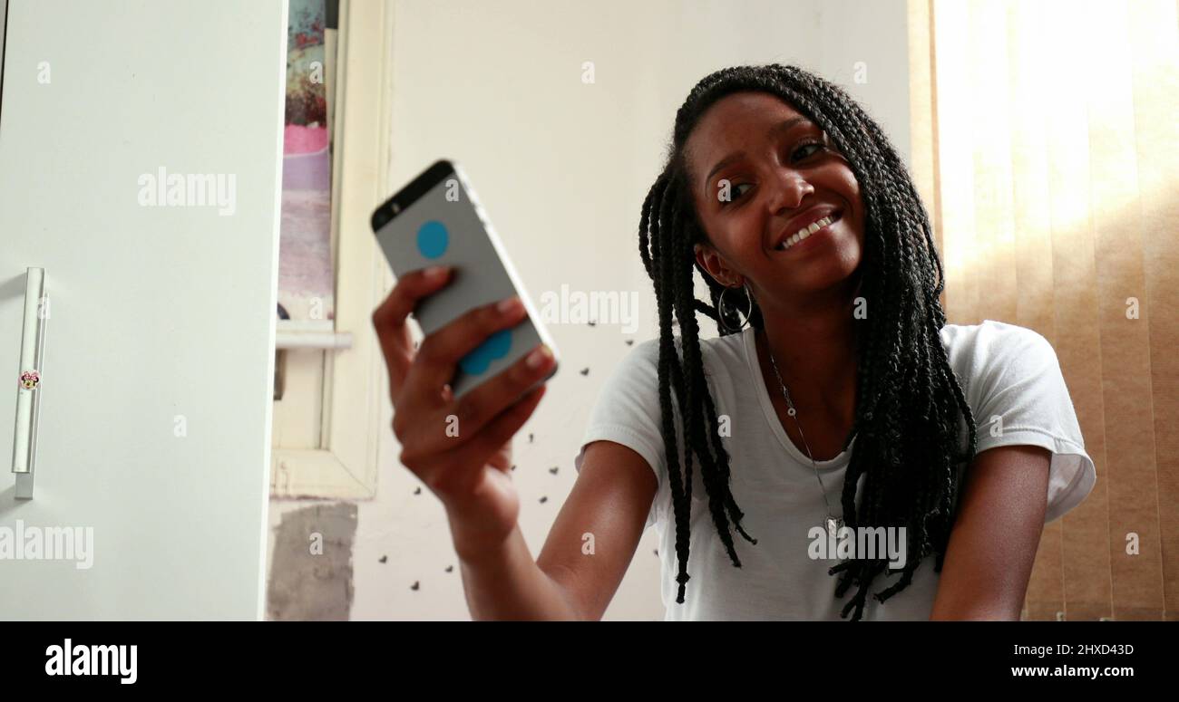 Black girl taking selfie with phone. Mixed race teen adolescent girl ...