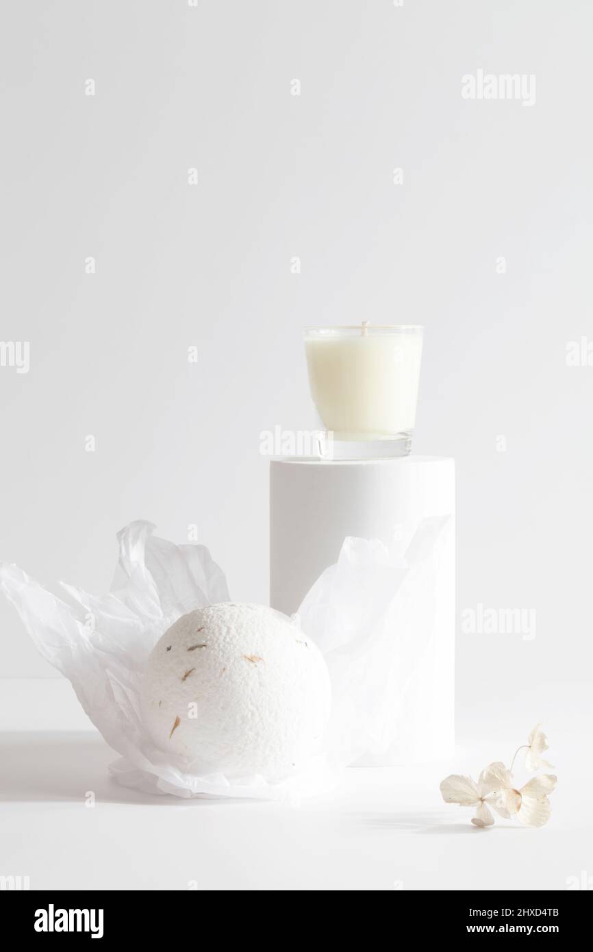 bath bomb and candle on podium on white background. Still life for wall ...