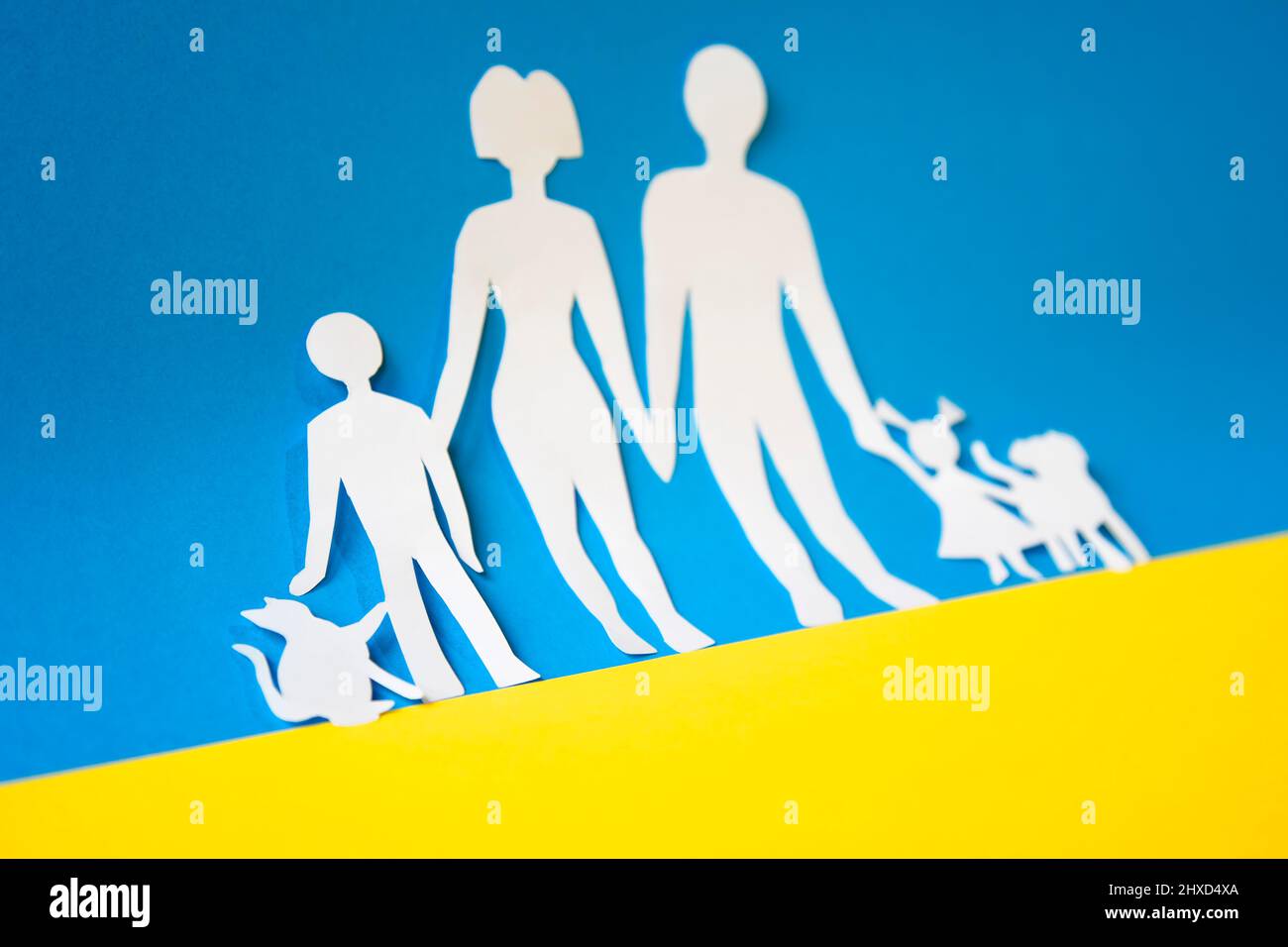 paper cutout of a family fleeing from war. parents with two children ...