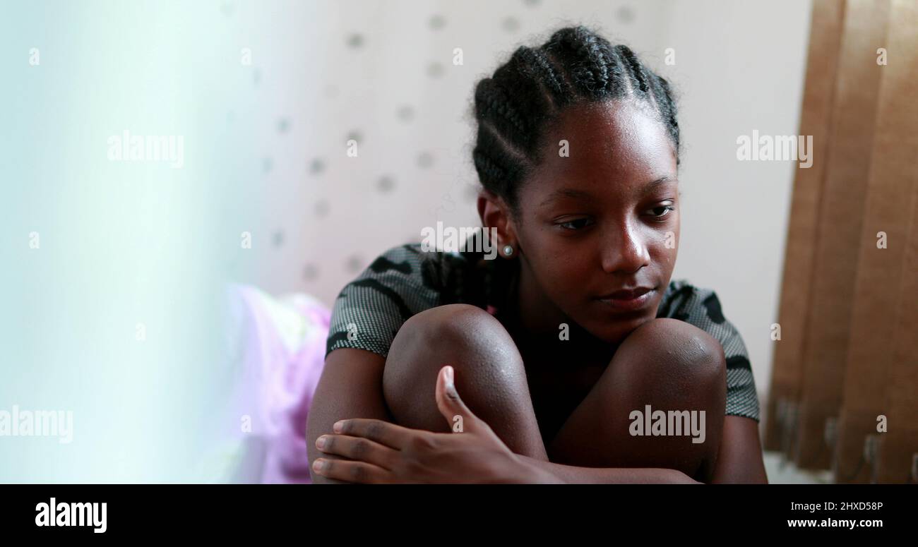 Pensive Black teen girl child thinking. Thoughtful sad depressed teenager adolescent girl Stock ...