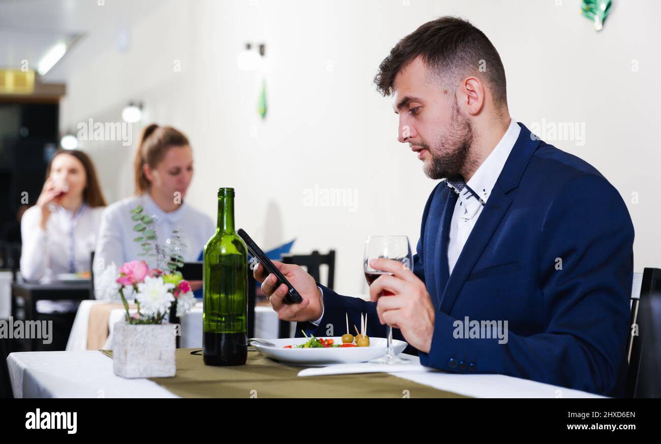 Gentleman is having dinner in luxury restaurante Stock Photo - Alamy