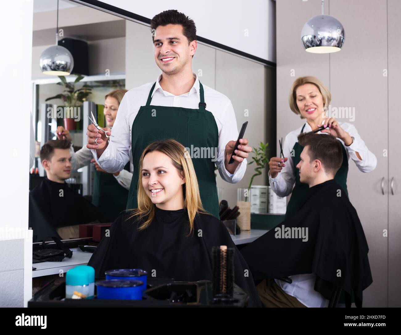 Hairdresser cuts hair at salon Stock Photo - Alamy