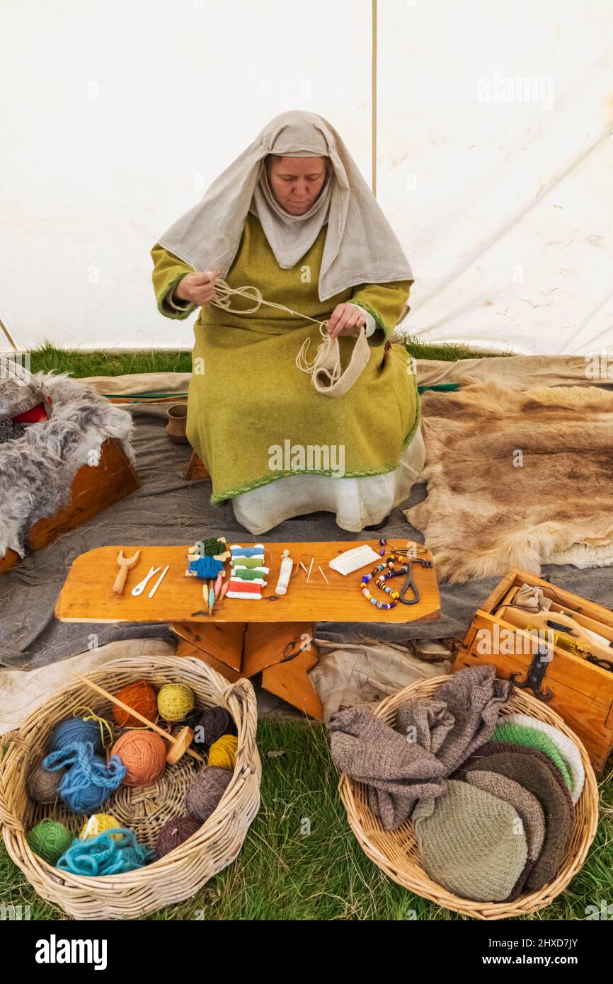 Female participant dressed in medieval costume knitting hi-res stock ...
