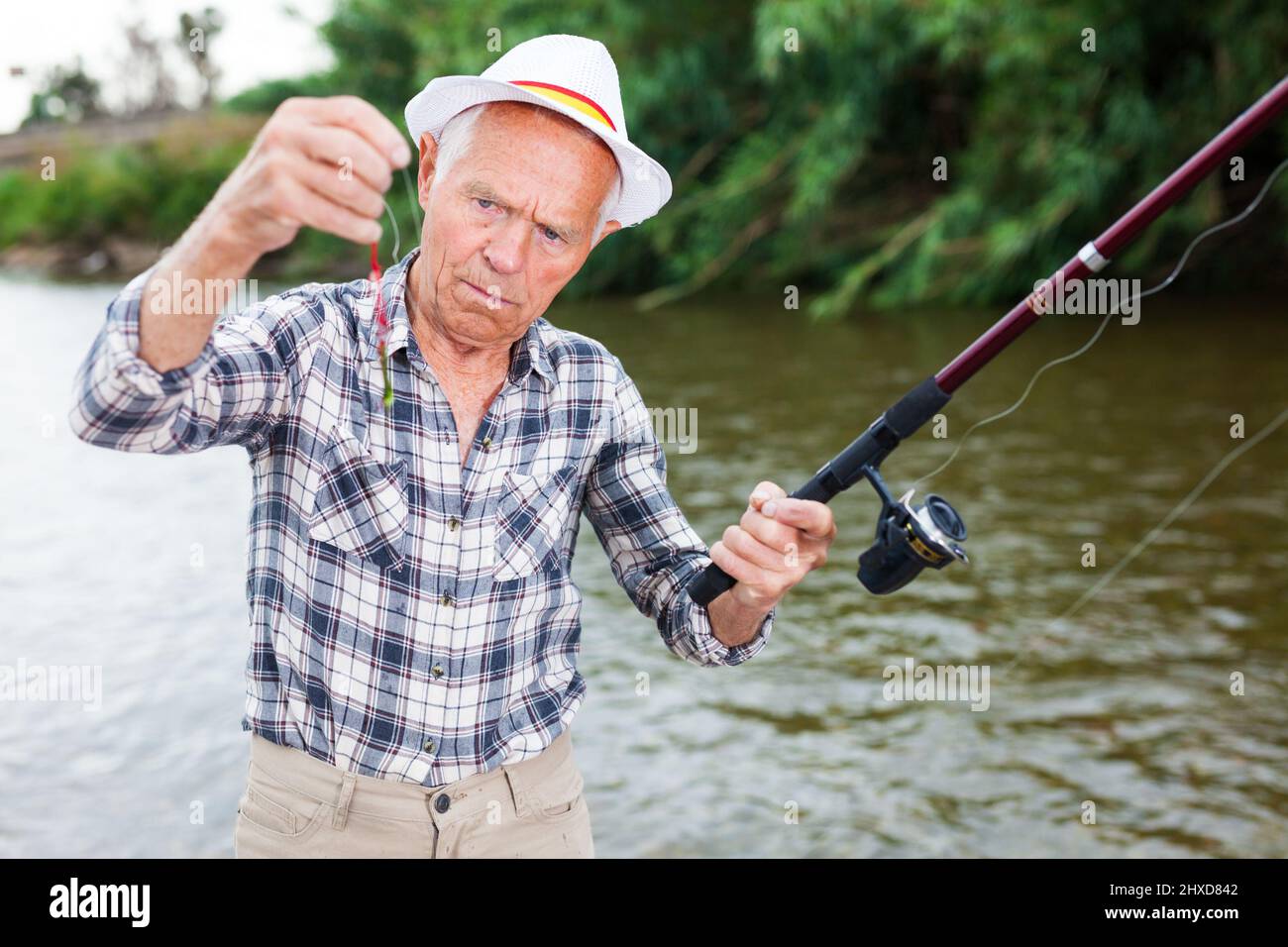 Fisherman changing bait on hook Stock Photo - Alamy