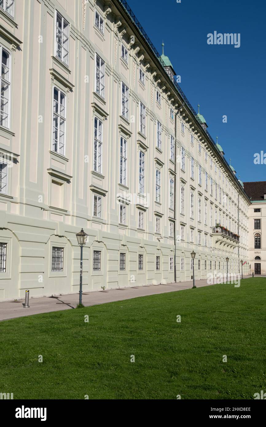 facade of the Leopoldine wing of Hofburg in bright sunshine ...