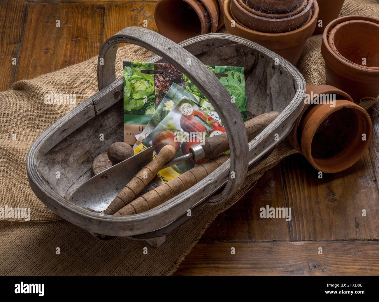 Traditional wooden garden trug with plant pots and seed packets Stock ...