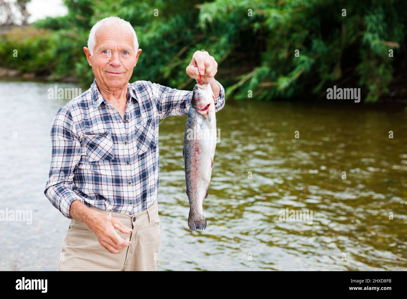 Happy aged man holding fishing hi-res stock photography and images - Alamy