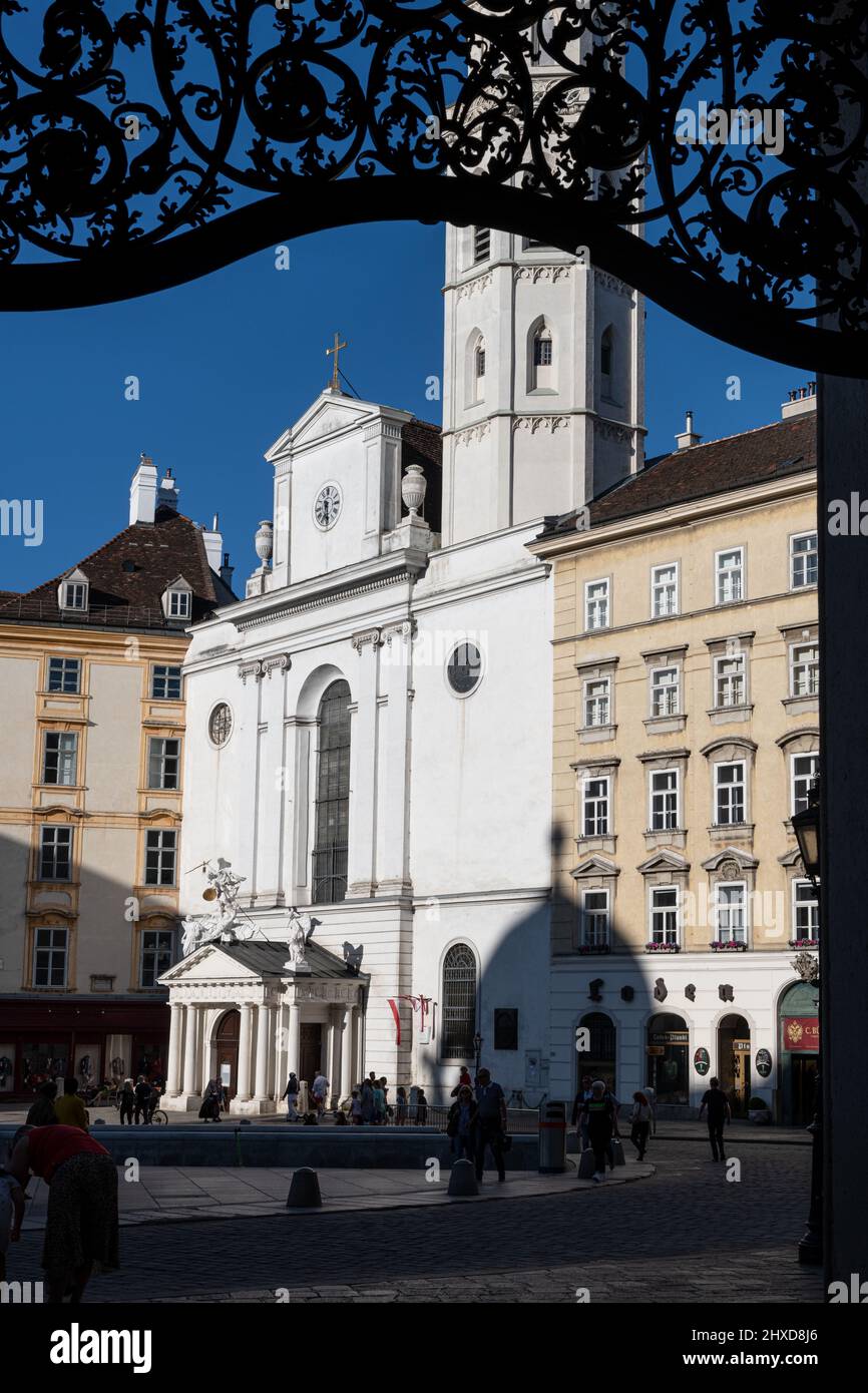 Michaelerkirche, St. Michaels church on Michaelerplatz square on bright ...