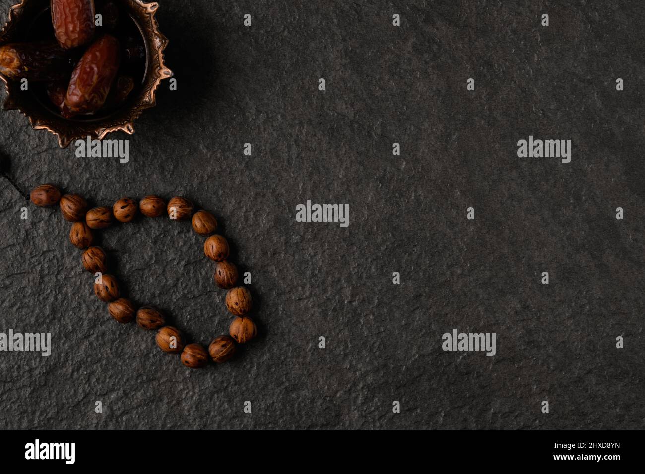 Dates and rosary beads top down view Stock Photo - Alamy