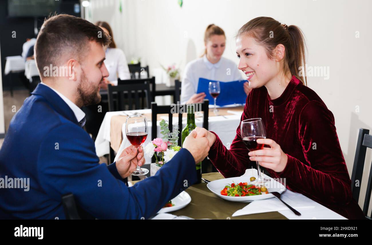 Gentleman with elegant woman are having dinner in luxury restaurante ...