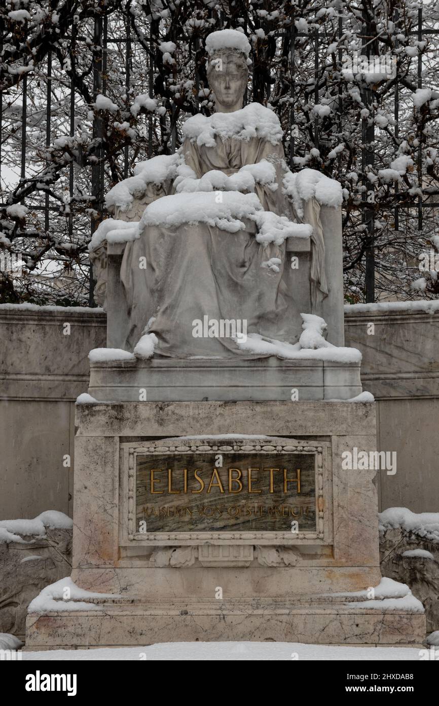 snow covered statue of Elisabeth Empress of Austria in Volksgarten park ...