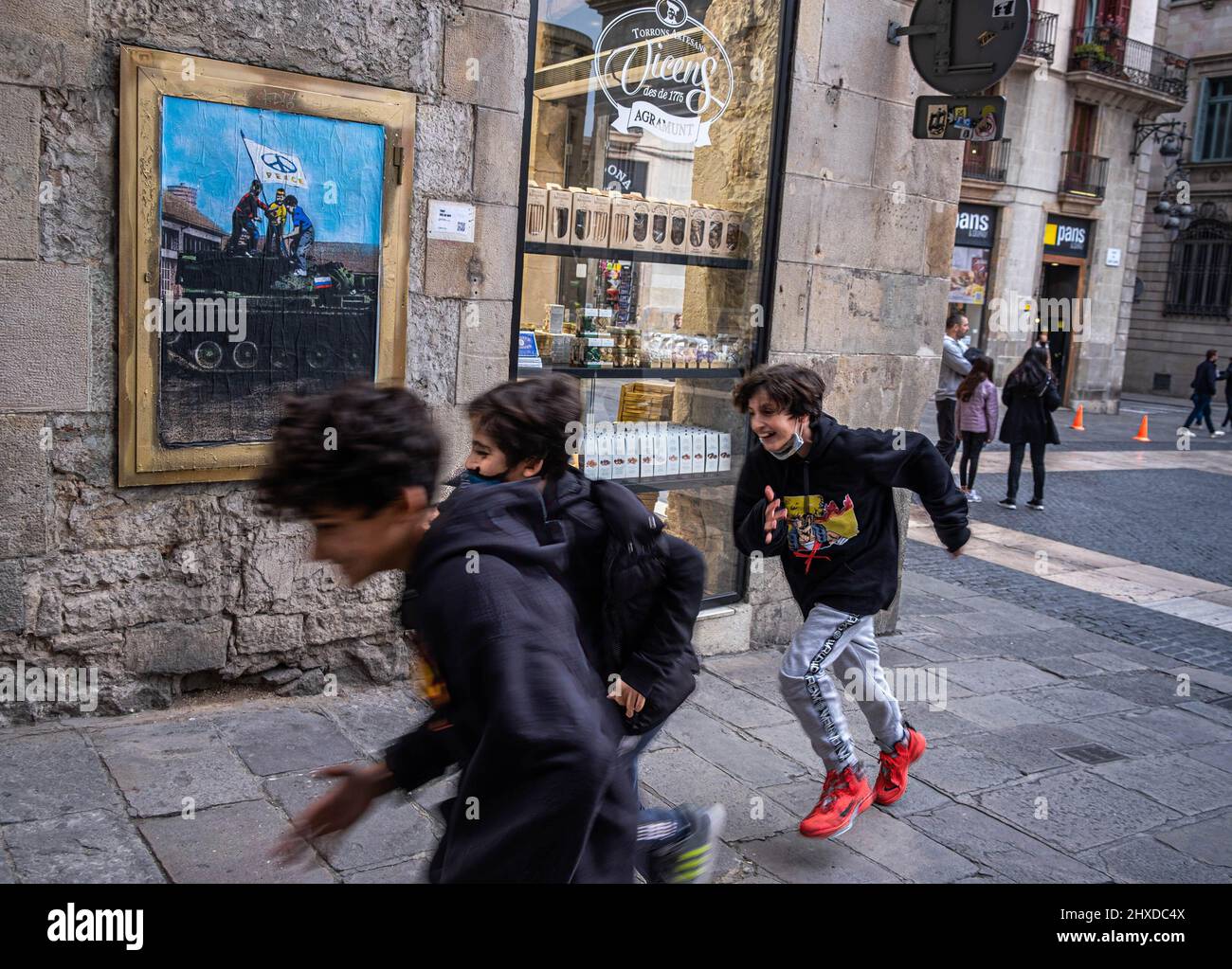 Barcelona, Catalonia, Spain. 11th Mar, 2022. Three children run past ...