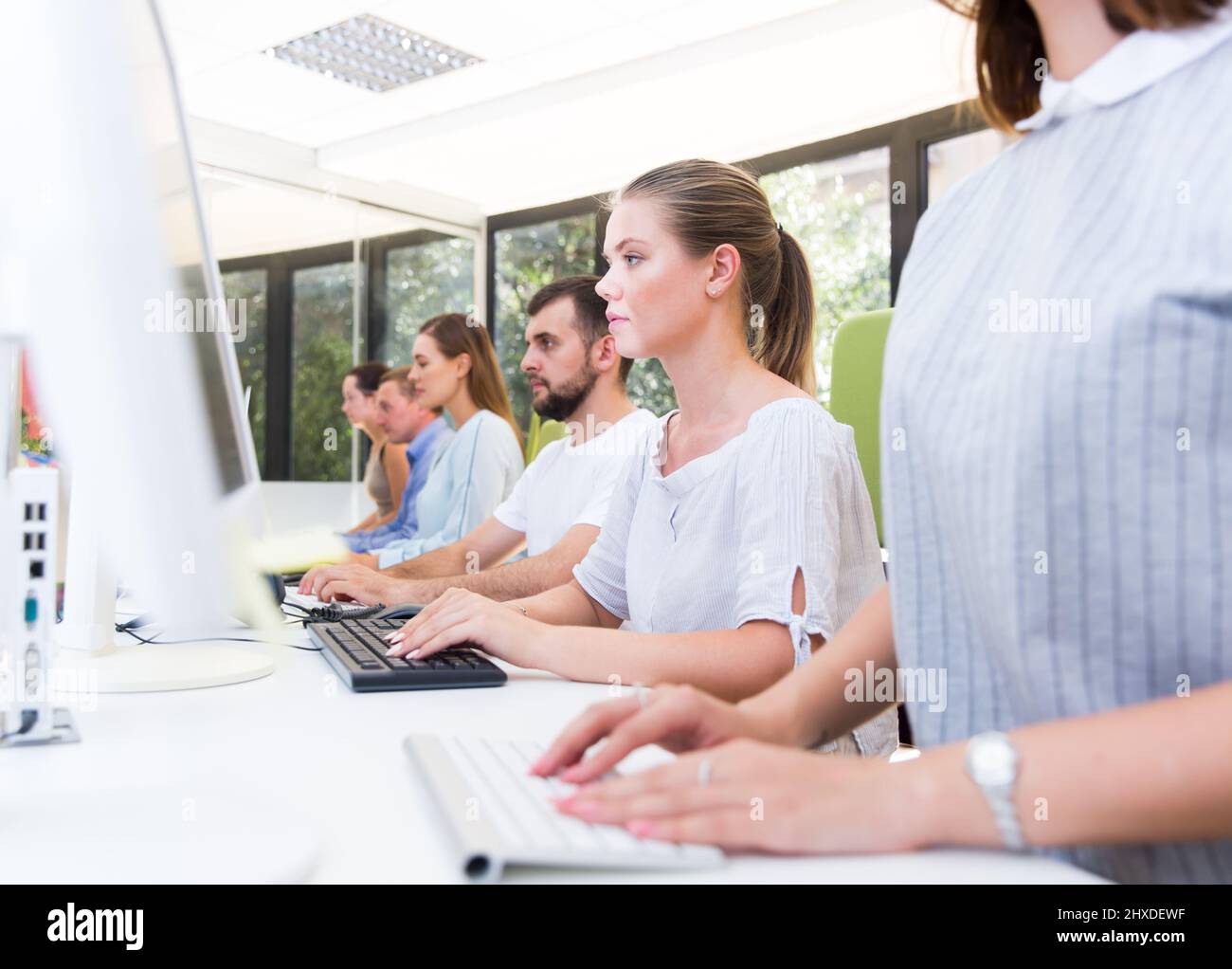 Side view of successful business people working at computers Stock ...