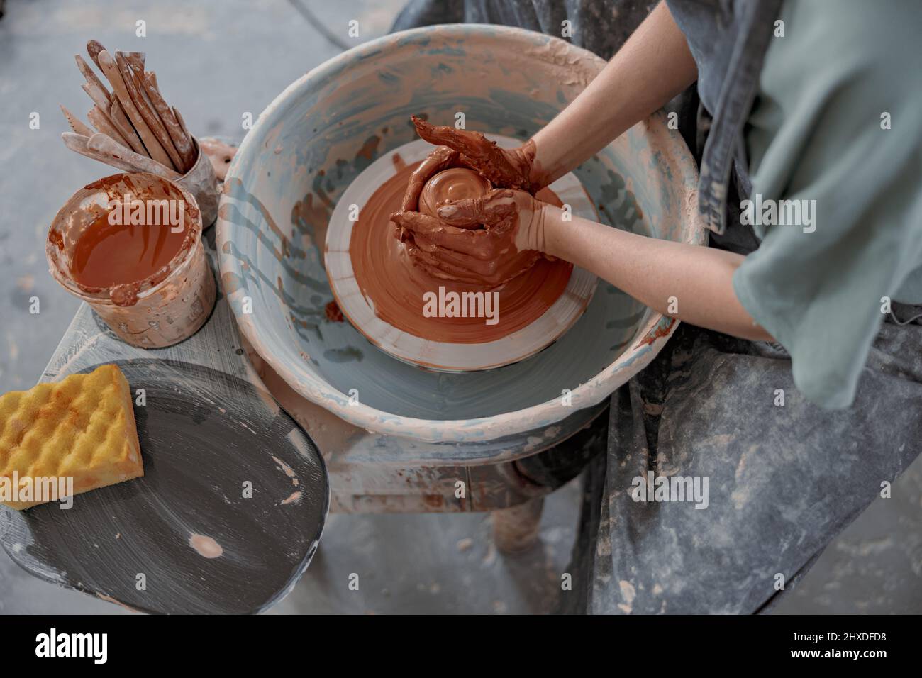 Clay artist modeling product on potter wheel in workshop Stock Photo ...