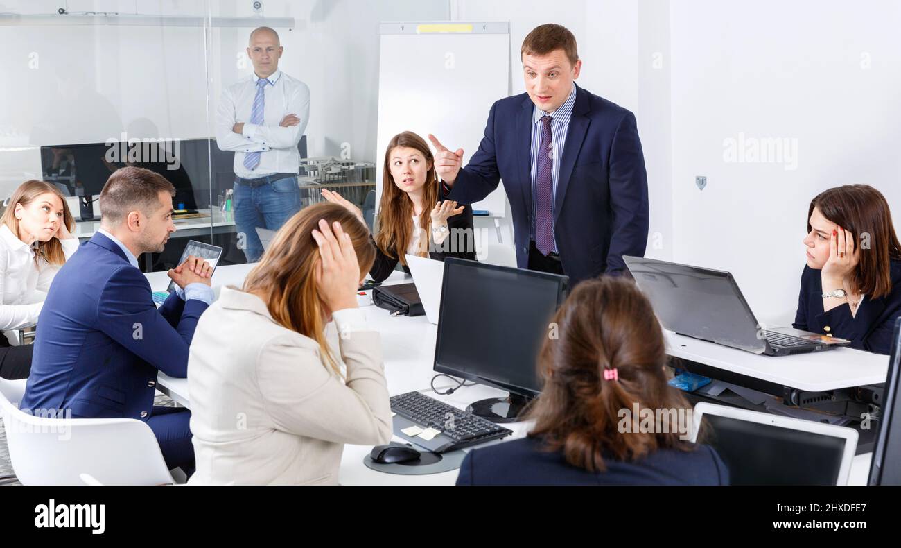 Businessman feeling angry to coworkers in office, pointing out mistakes ...