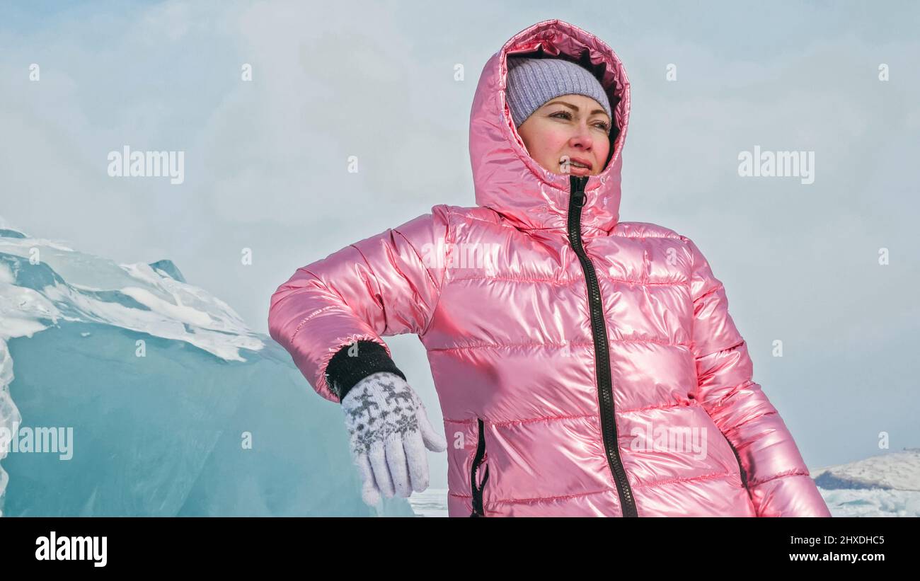 Girl walking on cracked ice of frozen lake Baikal. Woman traveler ...