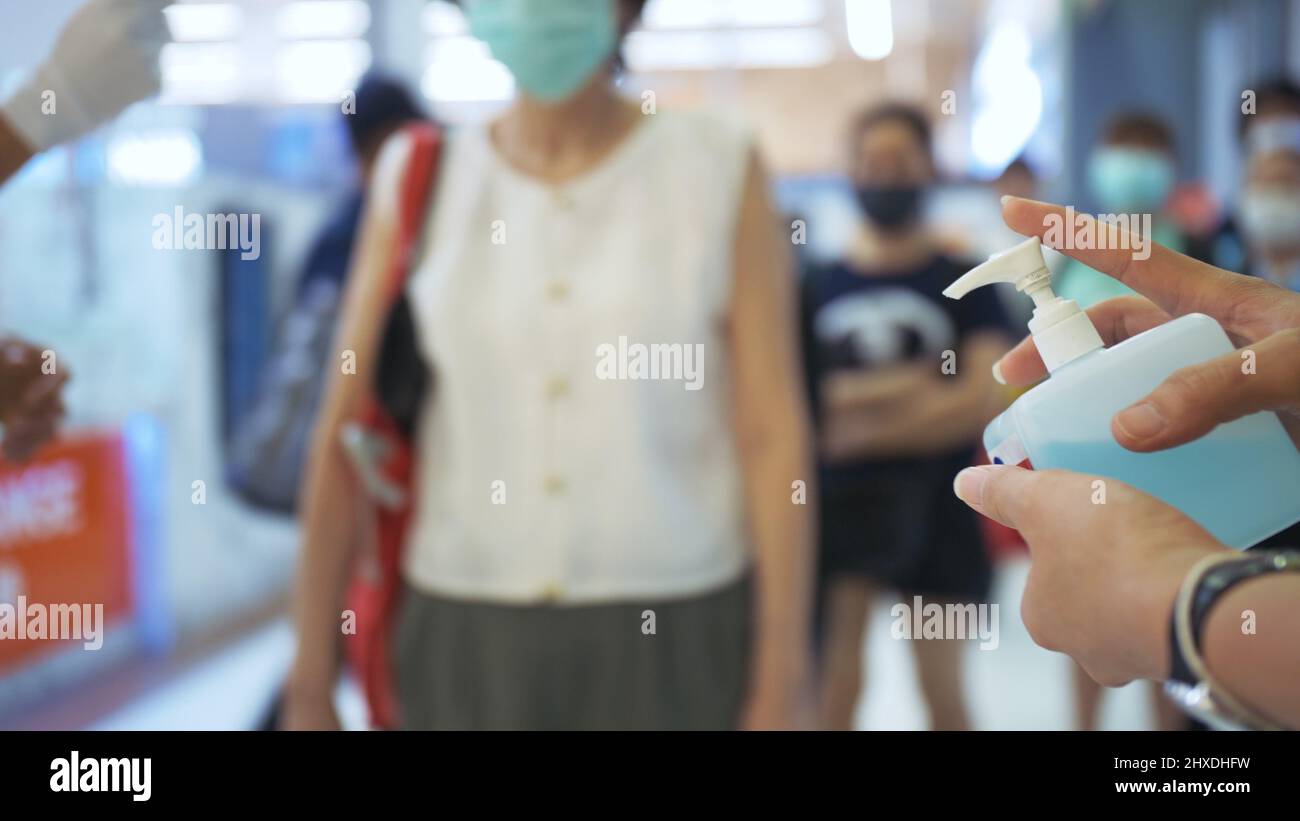 Hand Sanitizer gel. Hand treatment with alcohol. Temperature check at ...