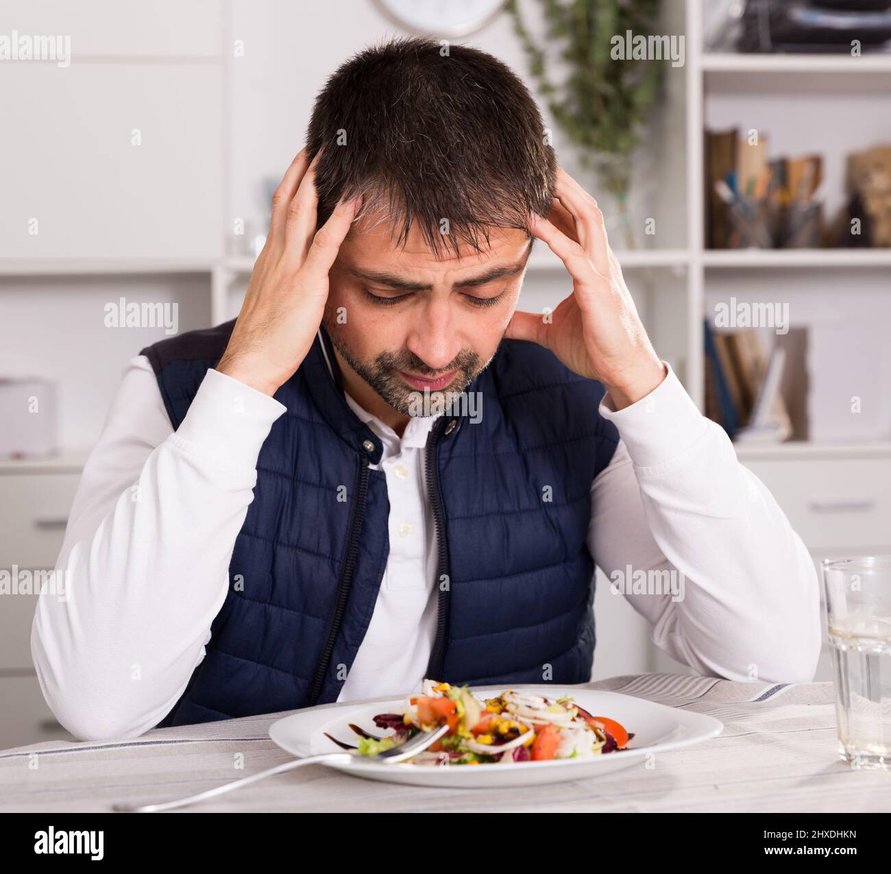 Portrait of sadly man before eating vegetable salad Stock Photo - Alamy