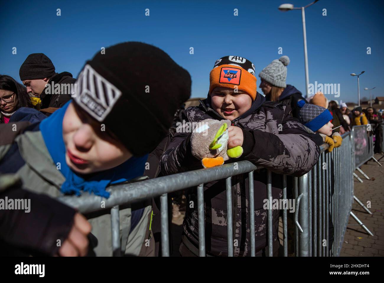 Ukrainian refugees kids queuing to board on a coach that takes refugees ...
