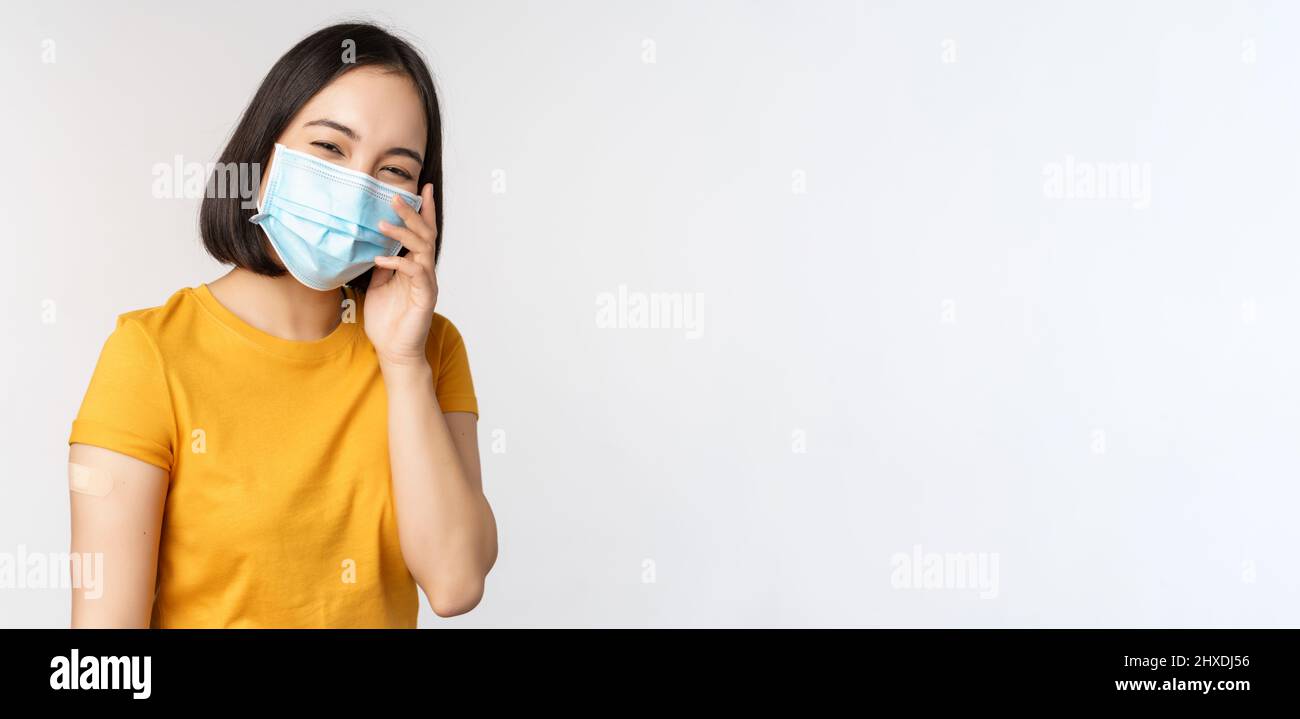 Covid-19, vaccination and healthcare concept. Cute asian girl in ...