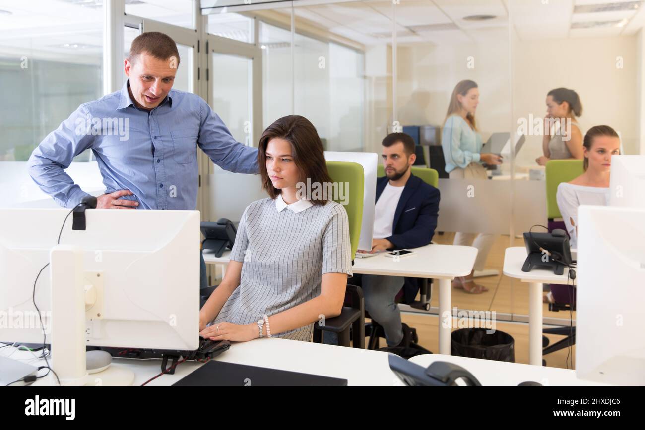 Chief executive explaining task to female Stock Photo - Alamy