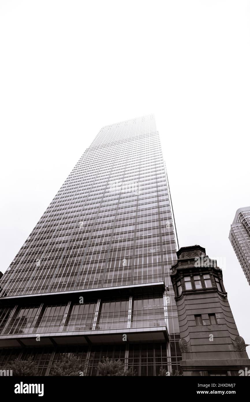 Vintage style skyscraper towering skyward and fading into mist ...