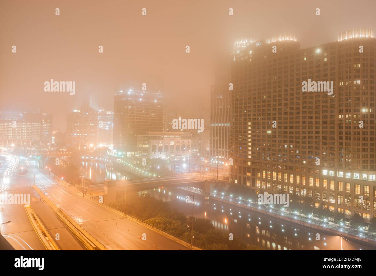 Through evening mist architecture and cityscape of Chicago, fade into ...