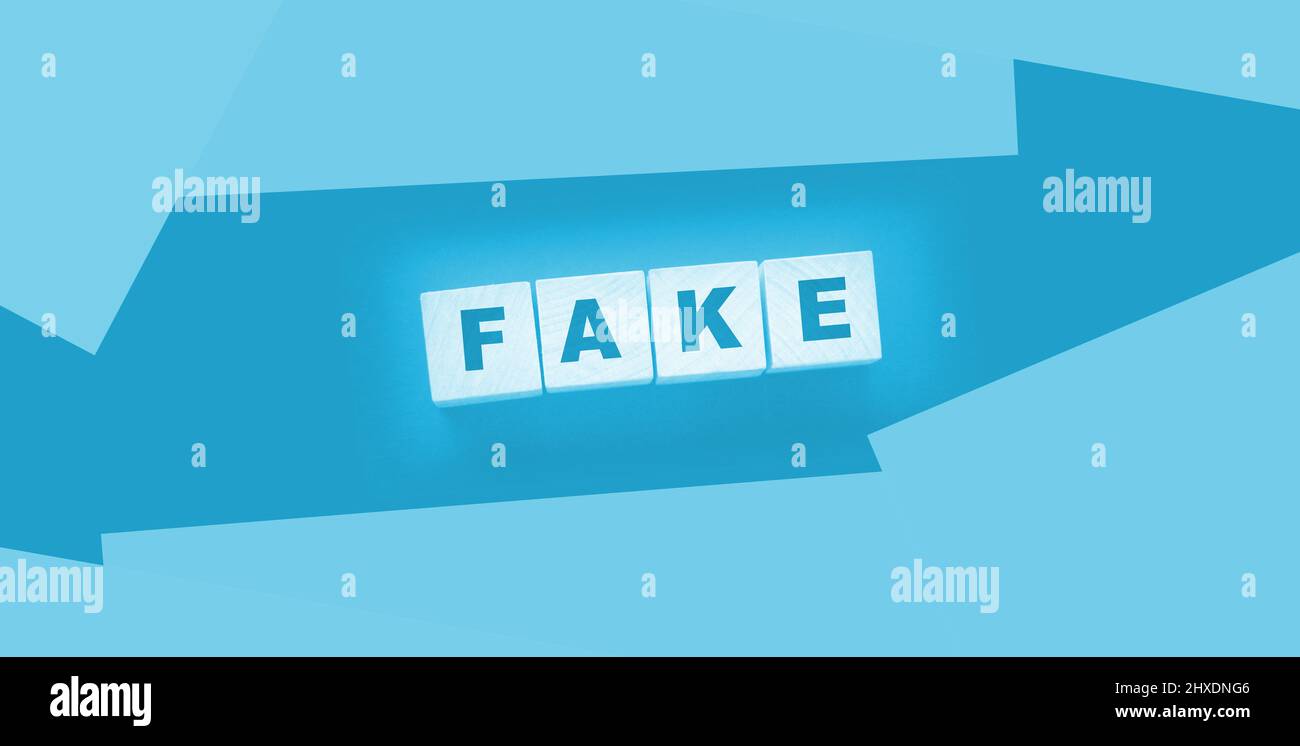 FAKE word written in wooden blocks on black background Stock Photo - Alamy