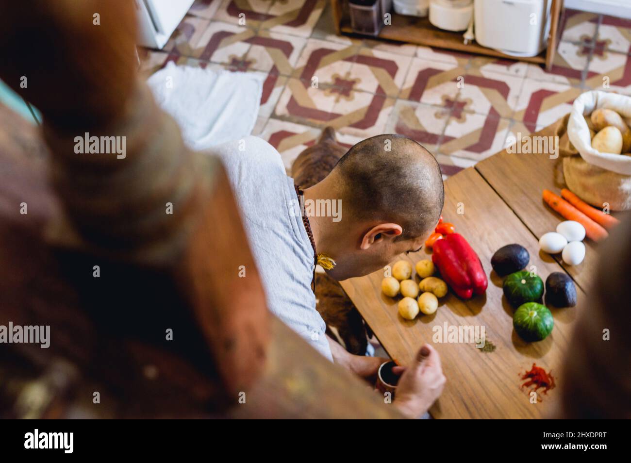 top view between the stairs of man in the kitchen of his house ...