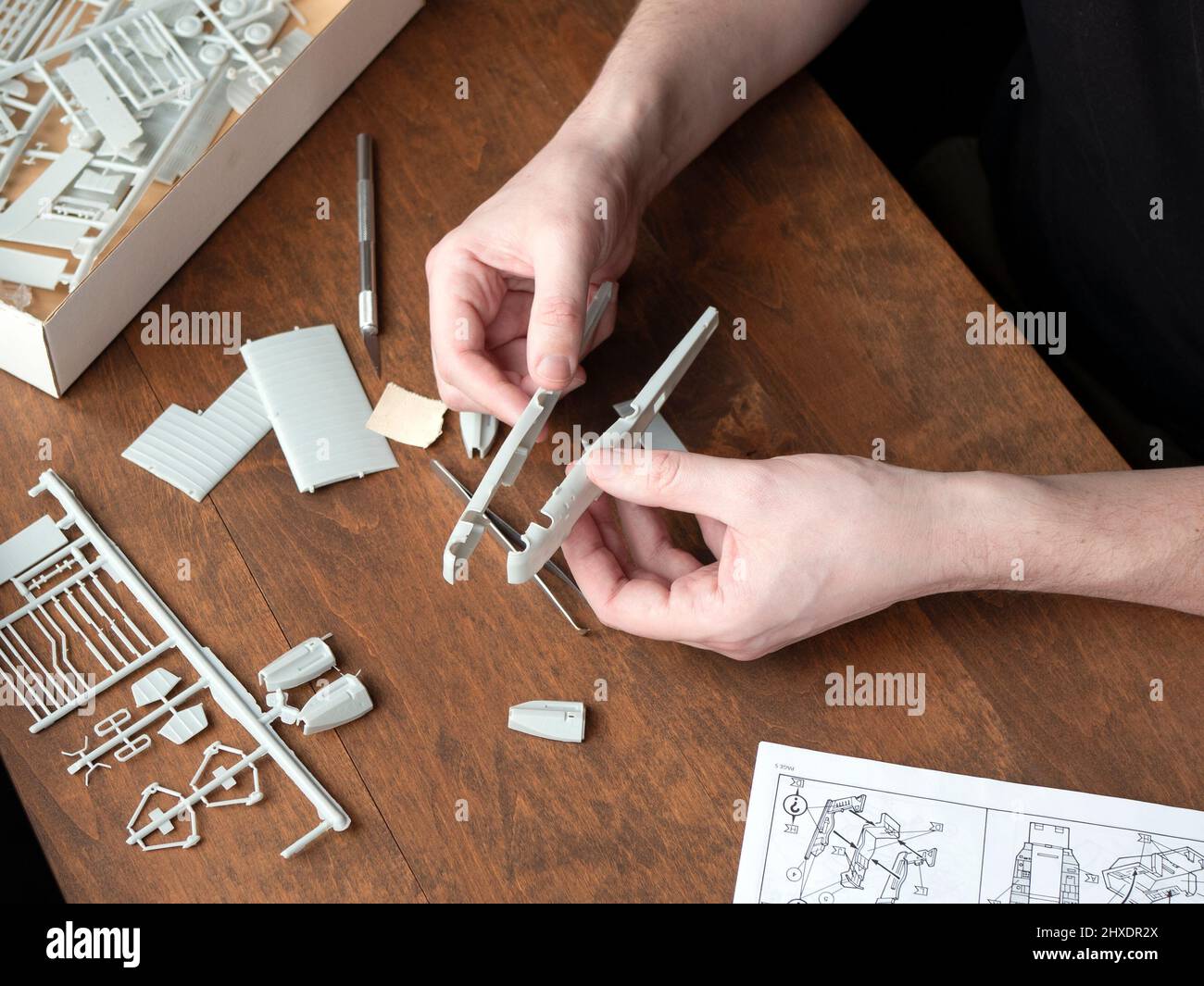 Plastic model builder is slapping a model together. Assembling the ...