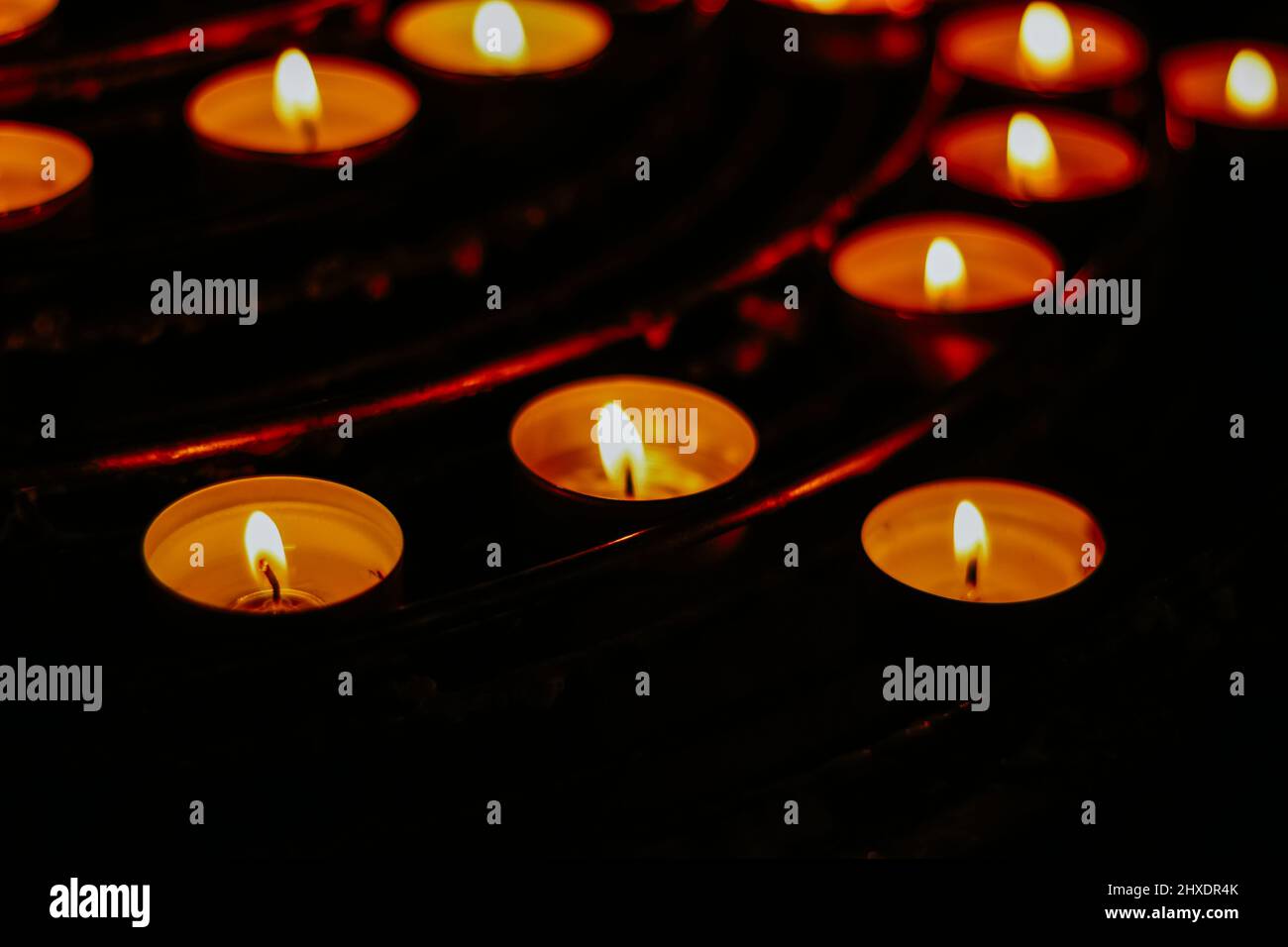 Small candles burning and glowing on the desk Stock Photo - Alamy