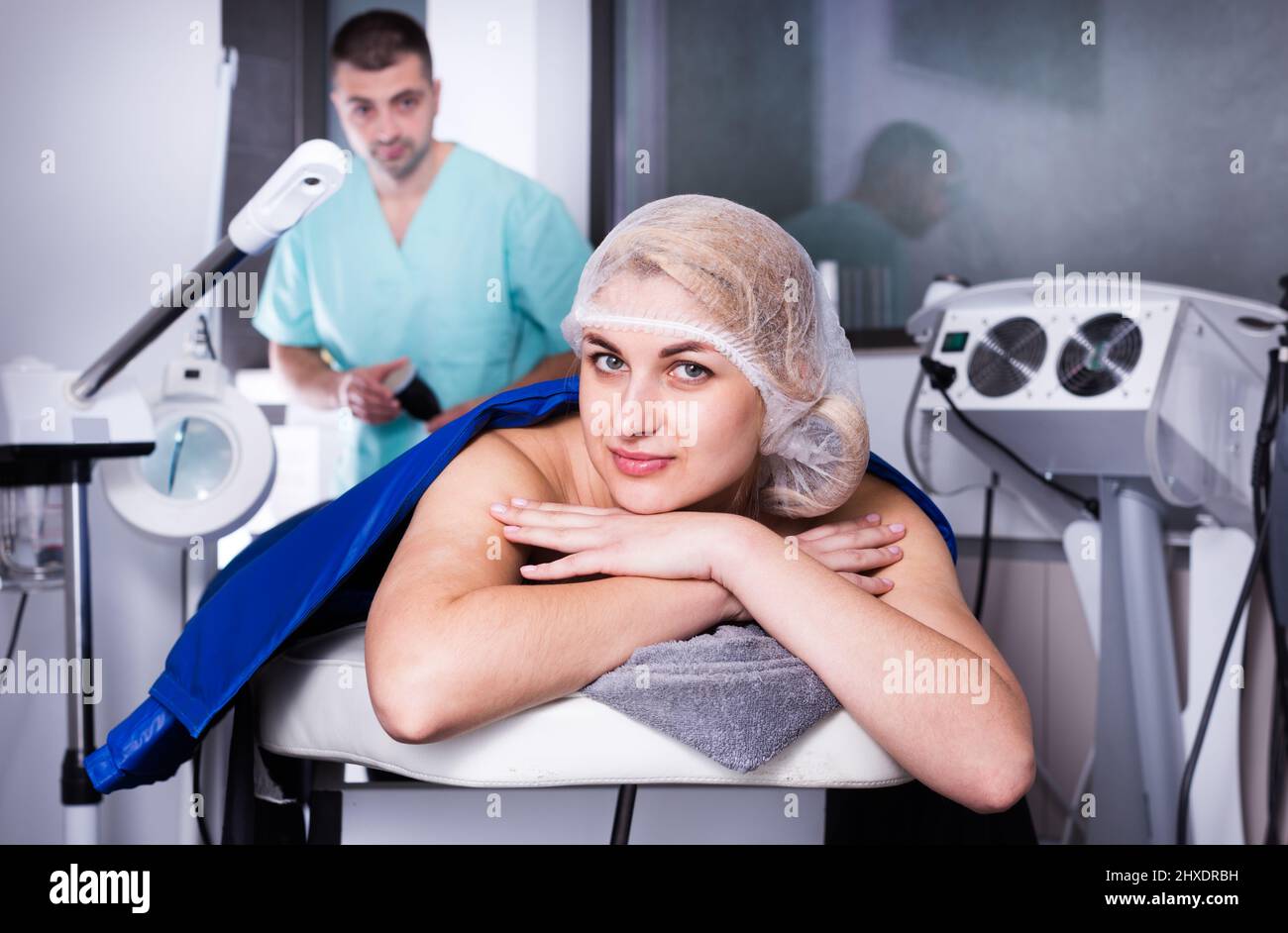 Female during body procedure in cosmetology office Stock Photo - Alamy