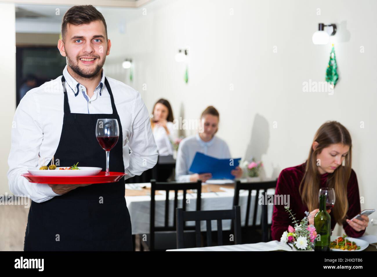 Portrait of waiter who is standing with dish in restaurante Stock Photo ...
