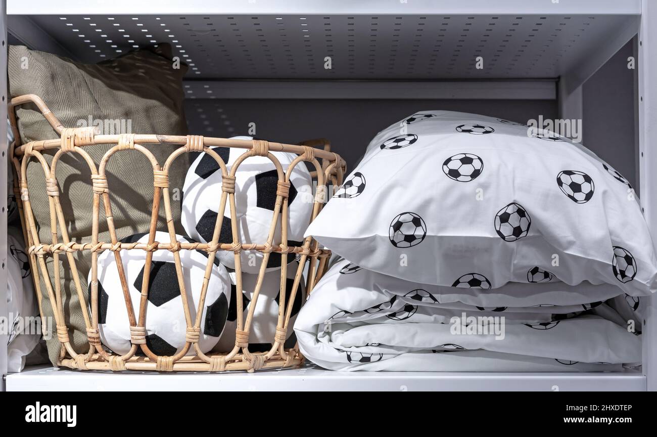 Bedding with football print. Soft toy soccer balls in a wicker basket ...